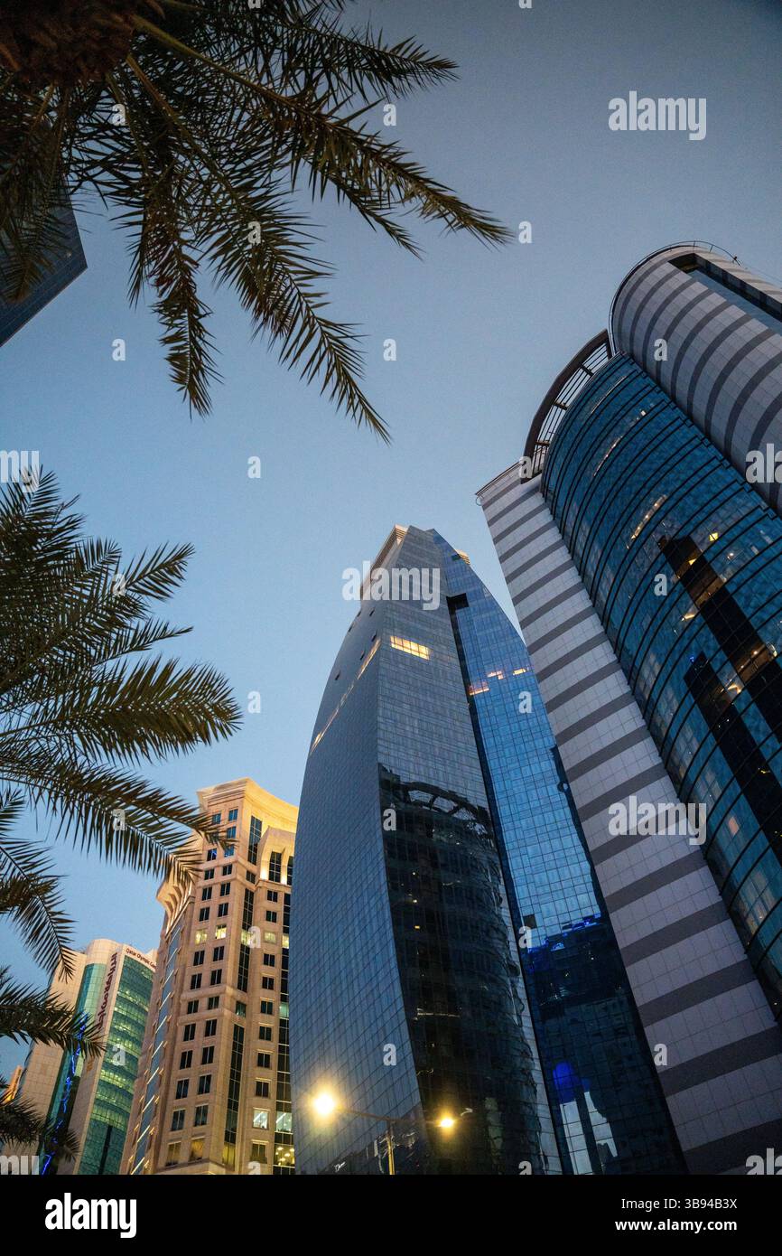 A captivating view of Doha's towering skyscrapers illuminated at night ...