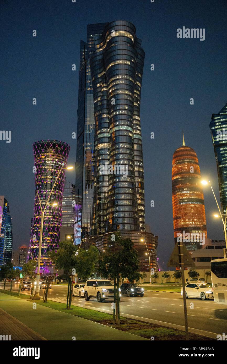 A captivating view of Doha's towering skyscrapers illuminated at night ...