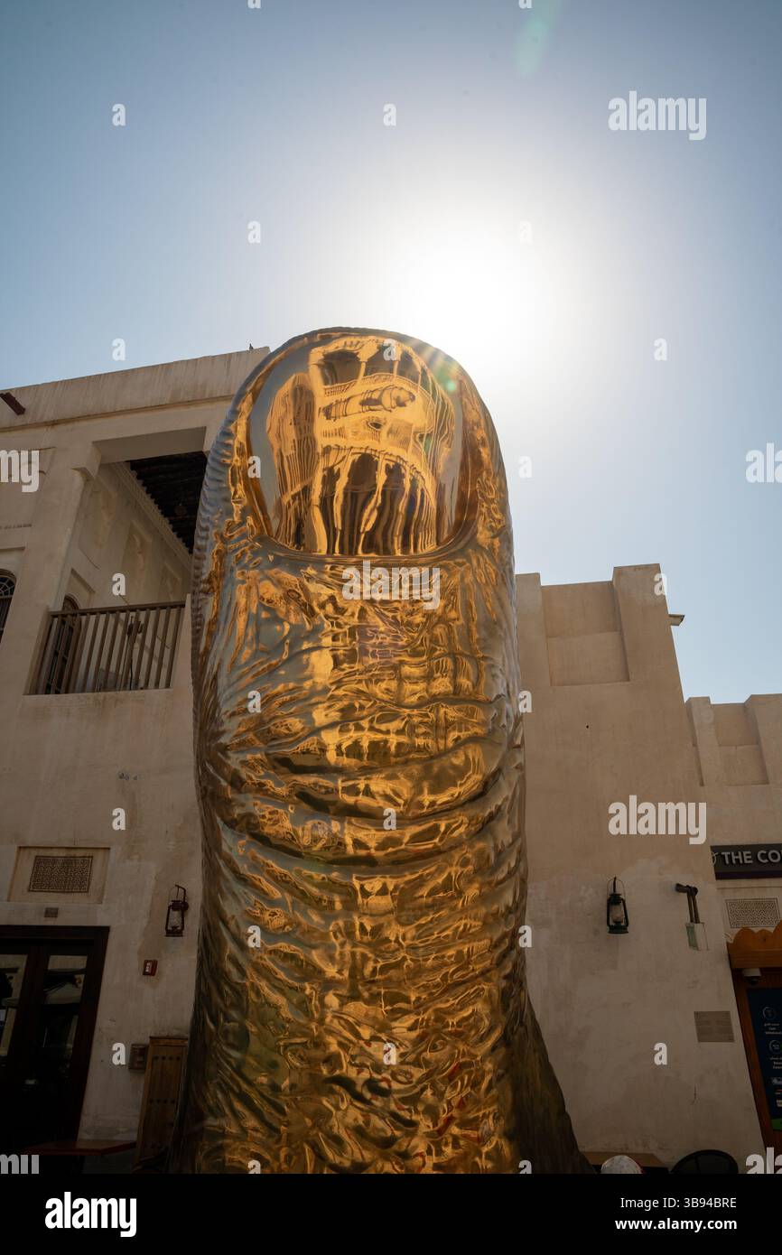 The iconic Golden Thumb statue at Souq Waqif in Doha, Qatar, standing ...
