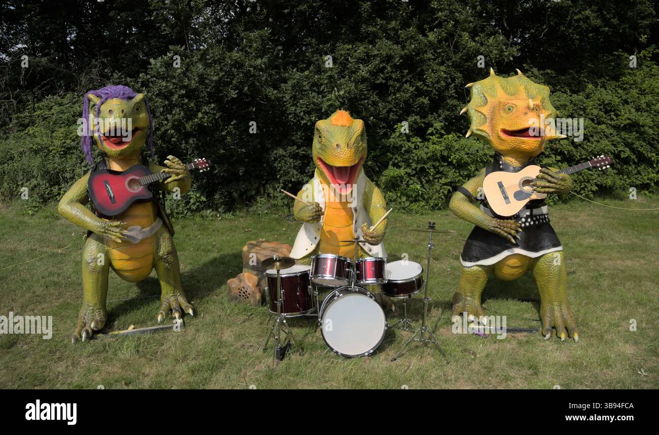 A band of three animatronic dinosaurs playing drums and guitars in the ...
