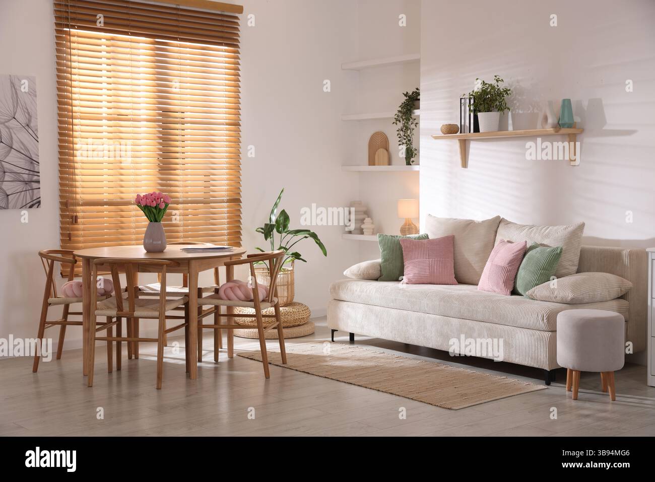Stylish dining table with chairs and comfortable sofa in room. Interior ...