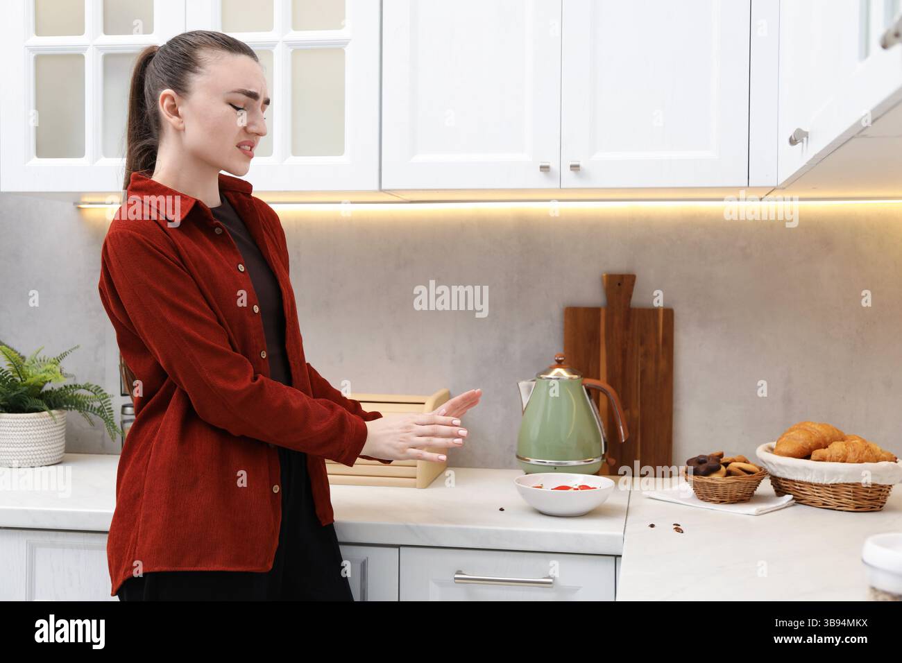Emotional woman afraid of cockroaches in kitchen. Pest problem Stock ...