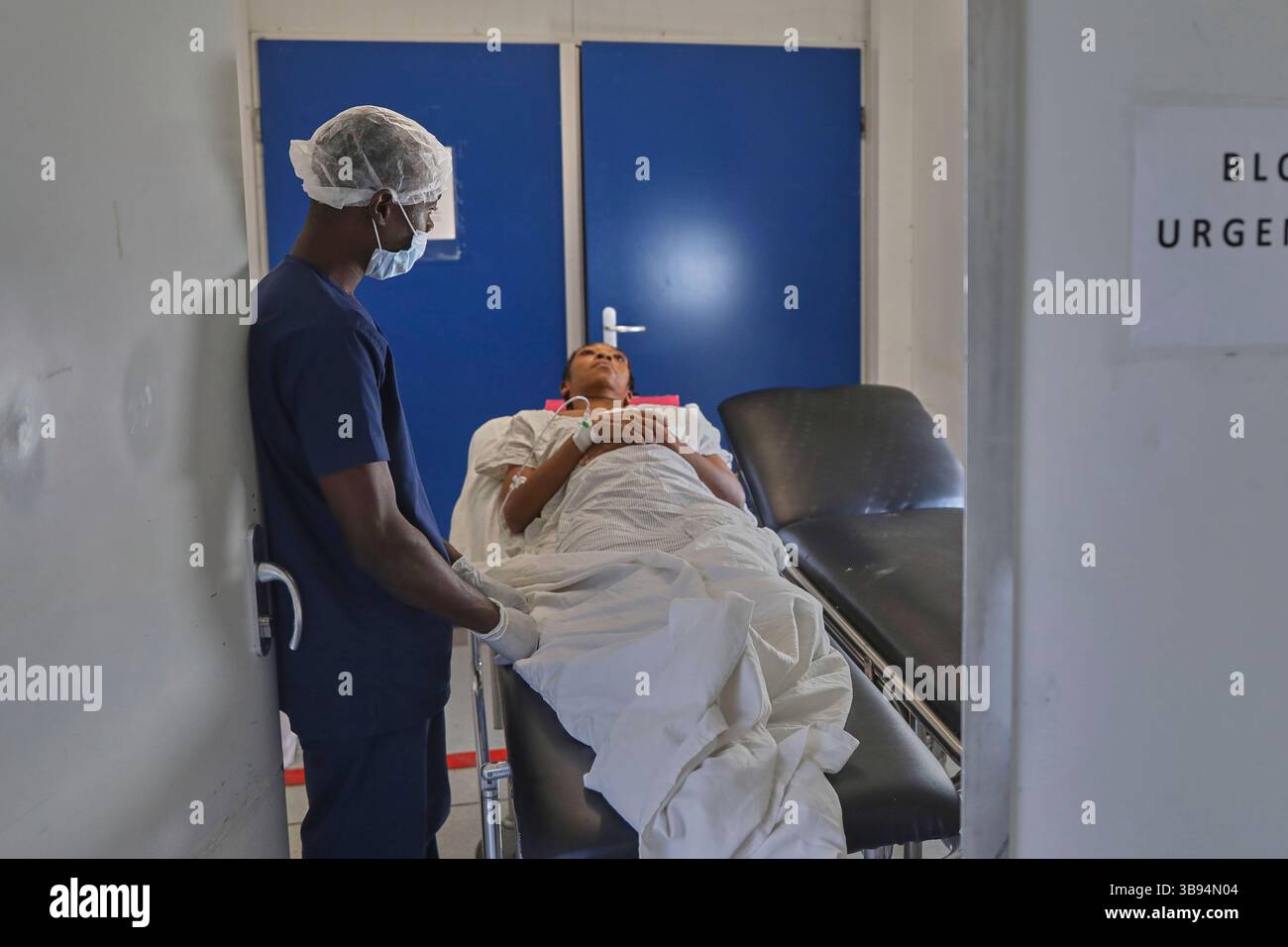 Medical staff transports a patient on a stretcher at a clinic run by ...