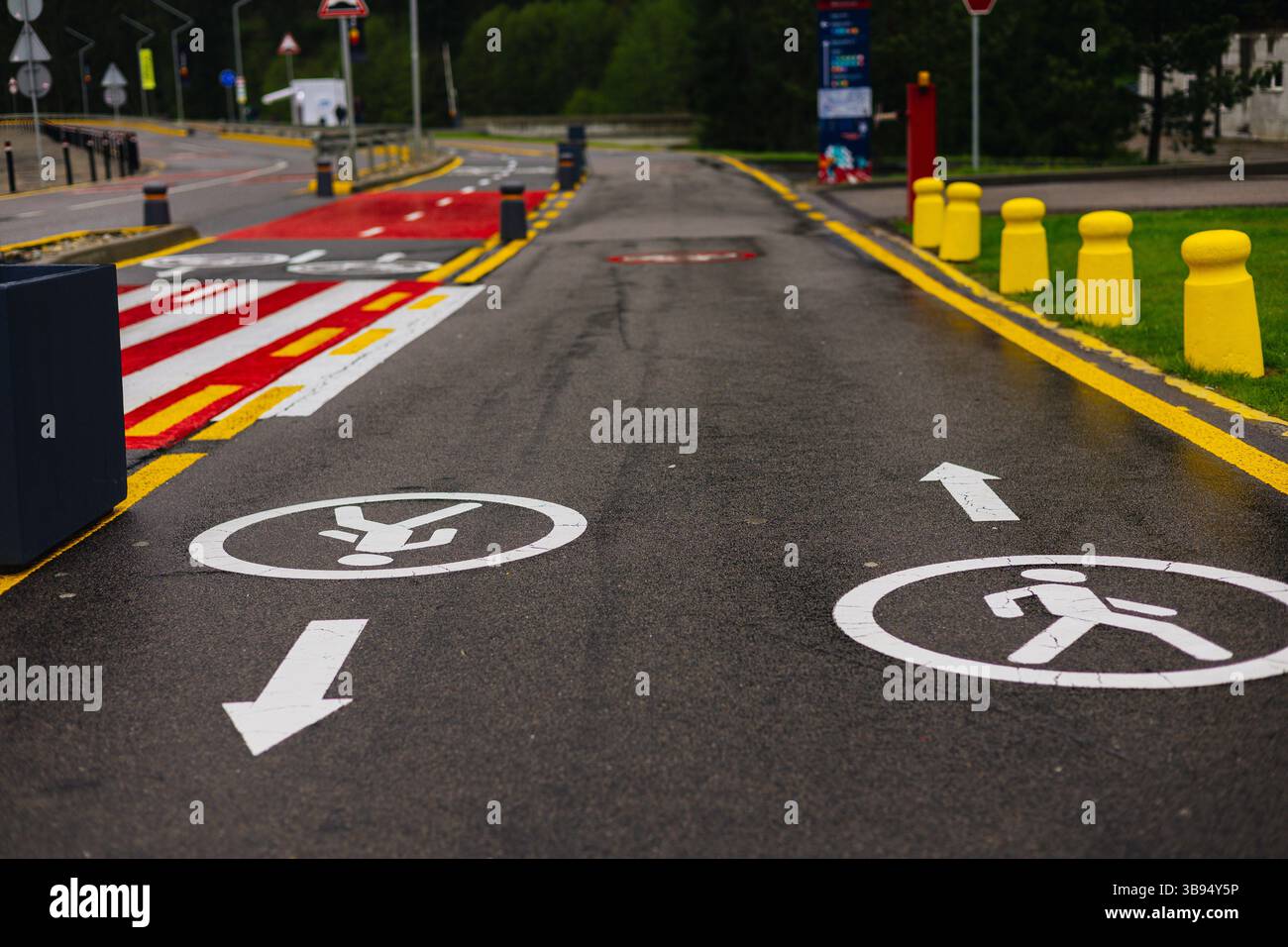 A designated pedestrian and bicycle path is marked with signs and lines ...