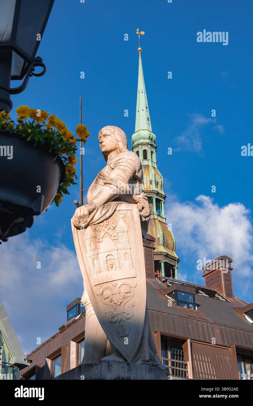 Statue of Knight and St. Peter's Church Spire in Riga, Latvia Stock ...