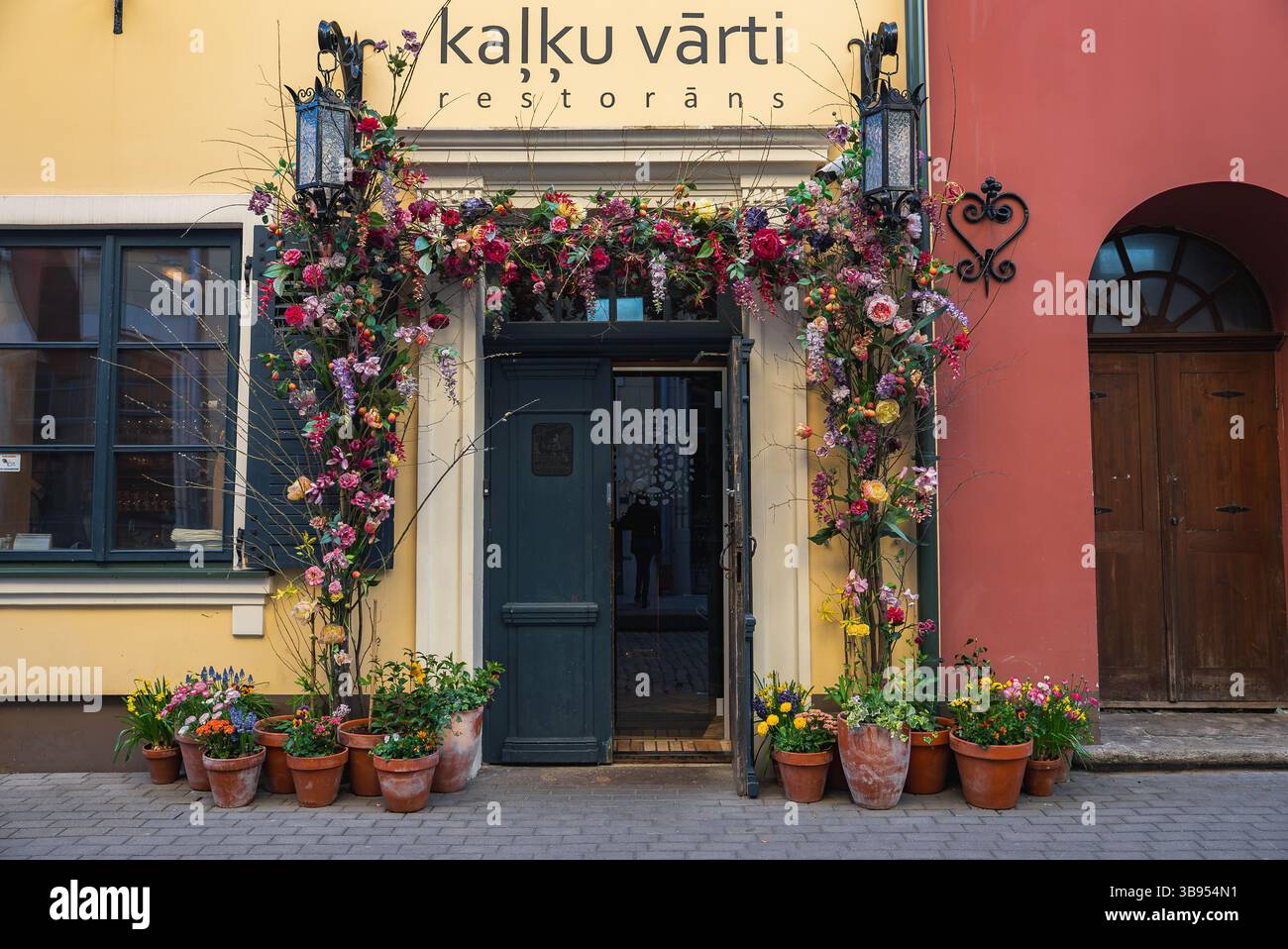 Entrance of Kalku Varti Restaurant with Floral Arch in Riga Old Town ...