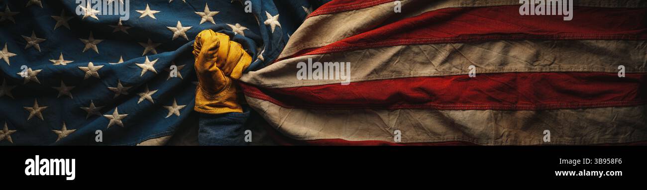 Worn work glove gripping old US American flag. Celebrating the American ...