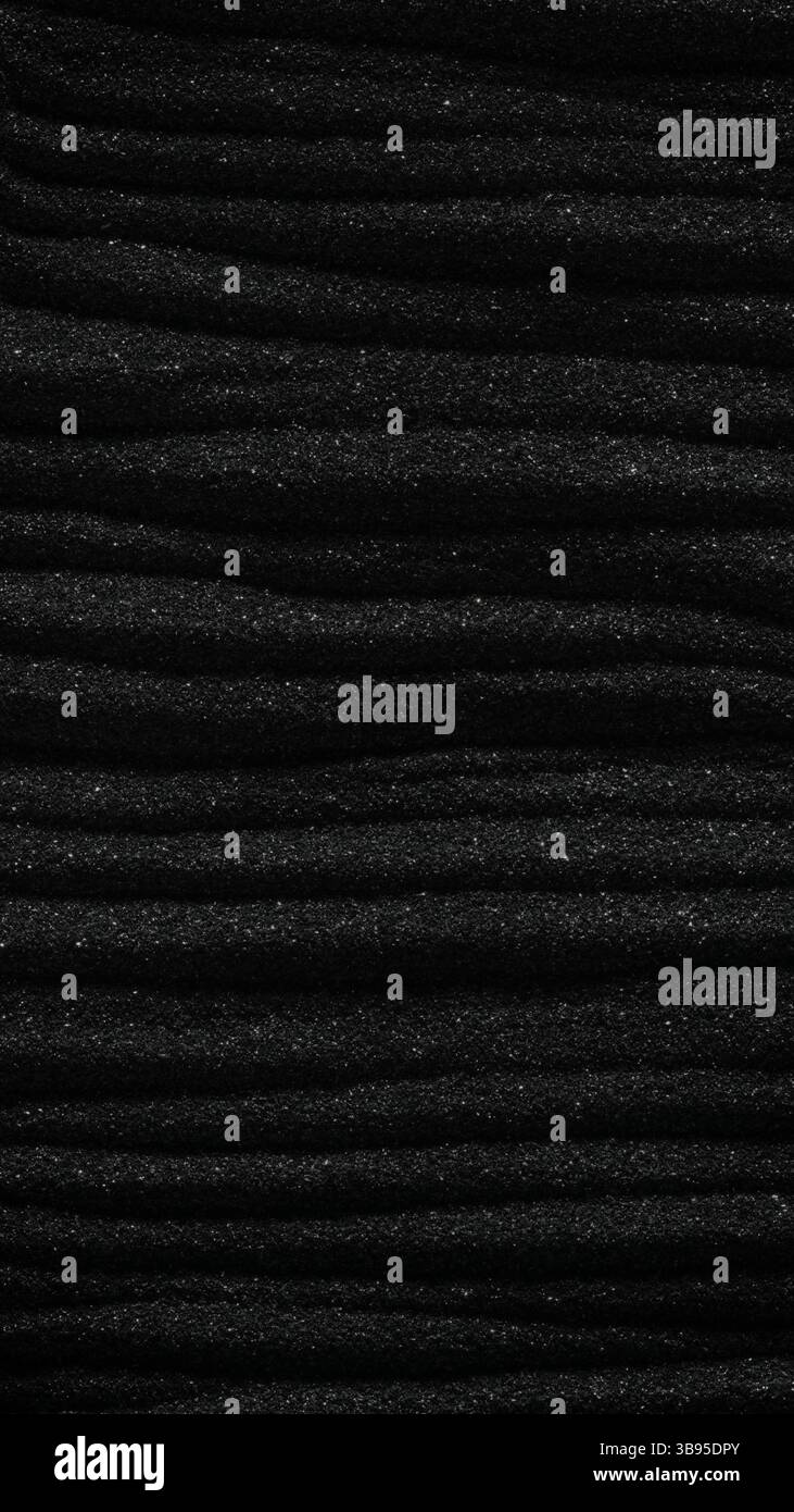 Dark black sand. Stripes and ripples of smooth volcanic sand texture or ...