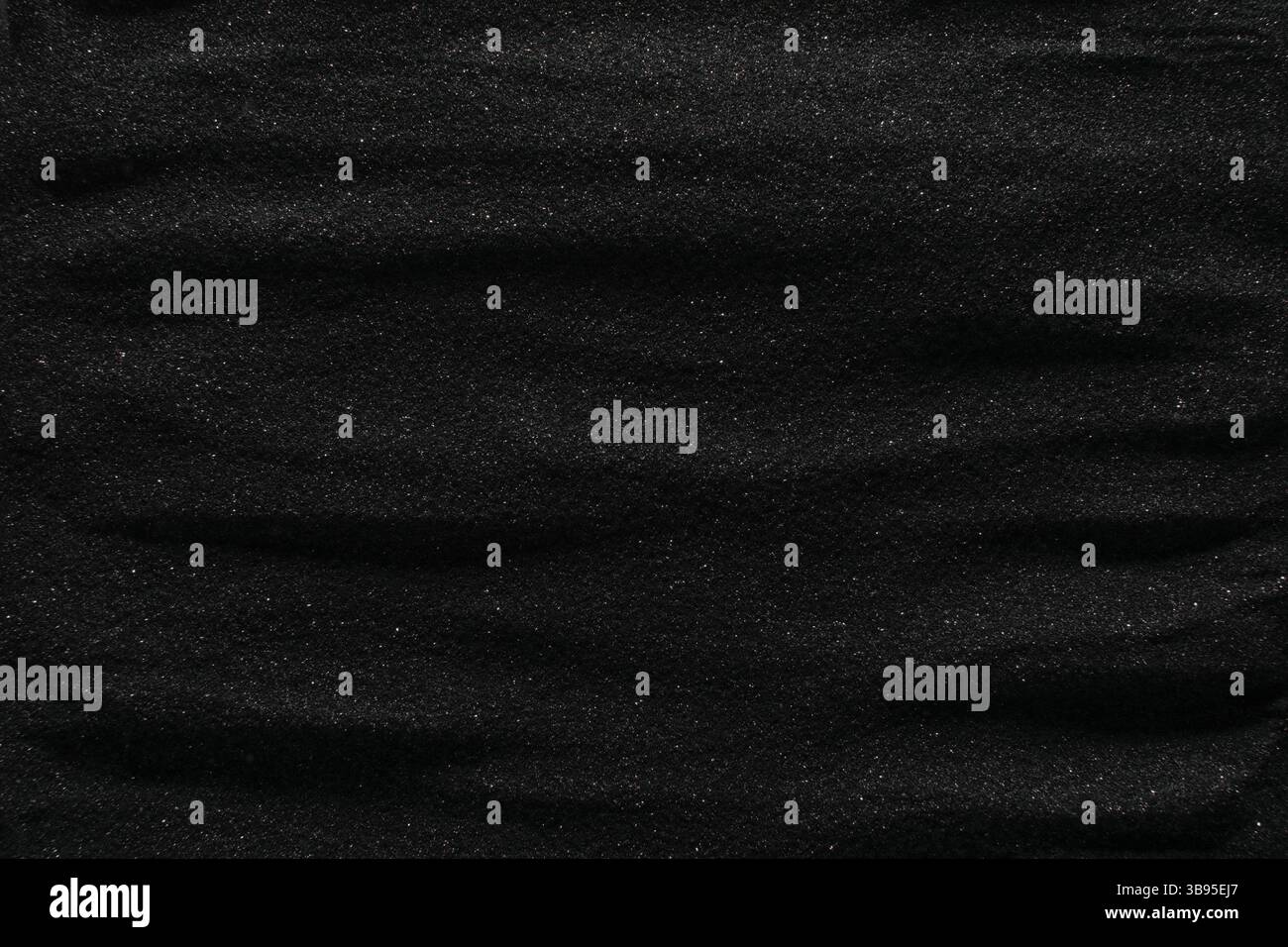 Dunes of dark black sand. Stripes and ripples of smooth volcanic sand ...