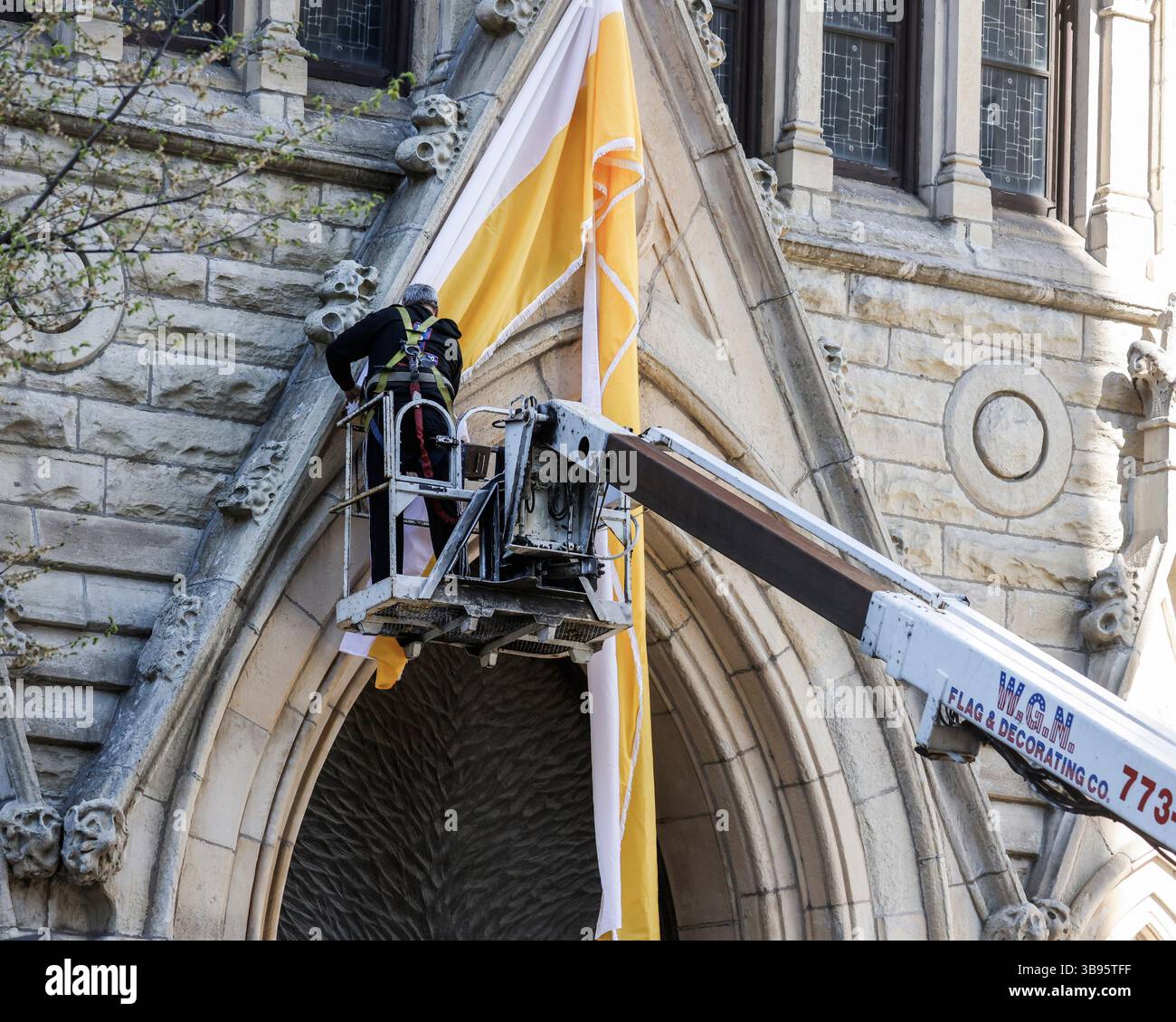 Chicago, United States. 11th Apr, 2025. A worker hands the Pope's ...