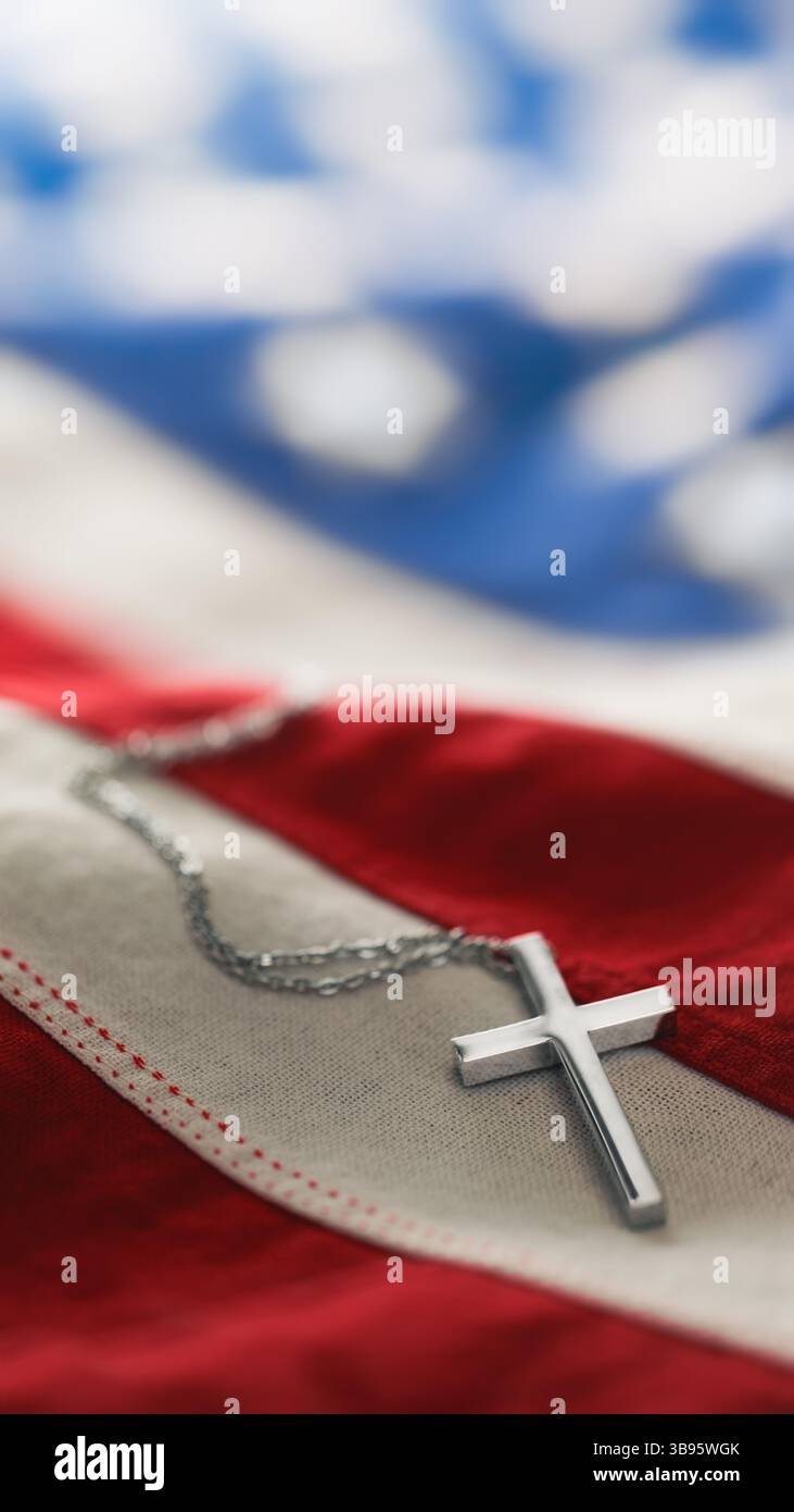 Christian cross necklace on American flag. For US Memorial Day ...