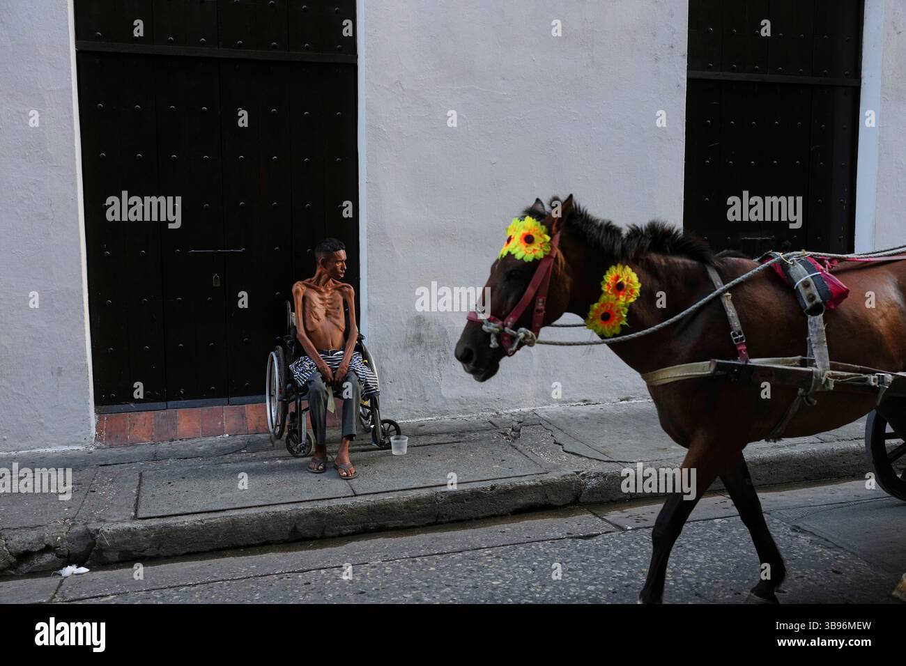 Reinel Elias Castillo, who suffers from muscular dystrophy, begs on a ...