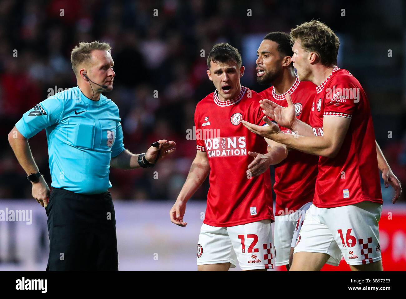 Bristol City players protest the red card shown to Rob Dickie of ...
