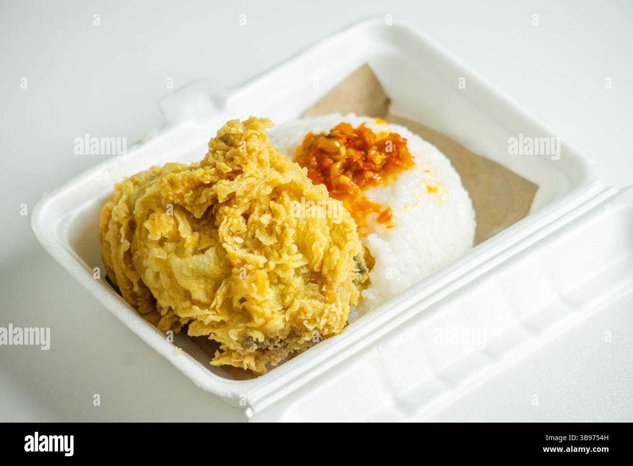 Ayam geprek (Indonesain spicy crispy fried chicken) with rice on ...