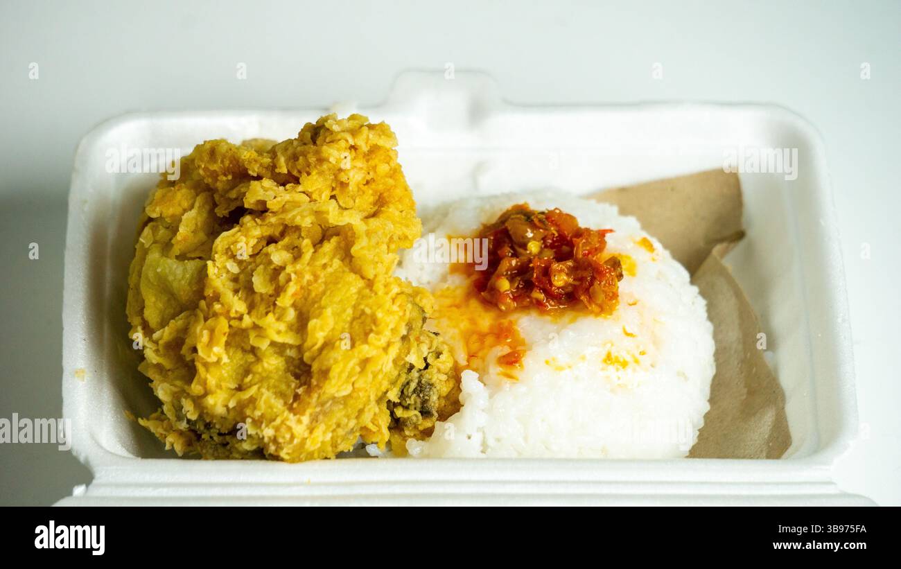 Ayam geprek (Indonesain spicy crispy fried chicken) with rice on ...