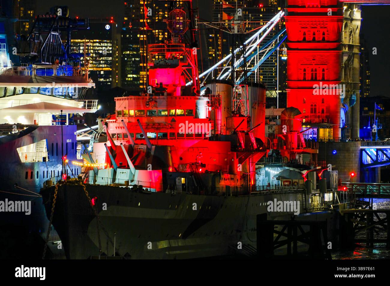 London, UK. 8th May, 2025. HMS Belfast is lit up in red for the final ...