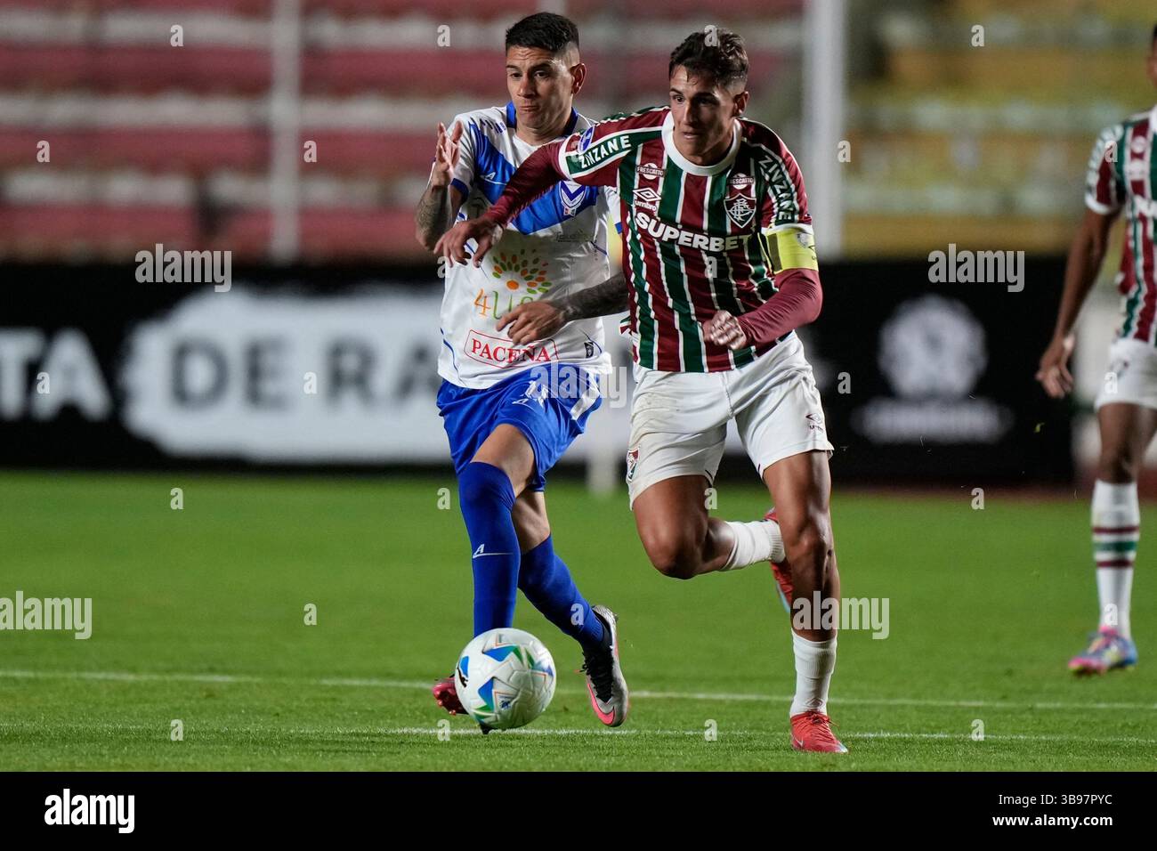 Facundo Bernal of Brazil's Fluminense, right, carries the ball past ...