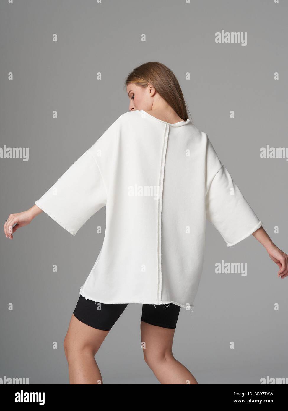 Elegant female model showcases contemporary fashion in a studio setting ...