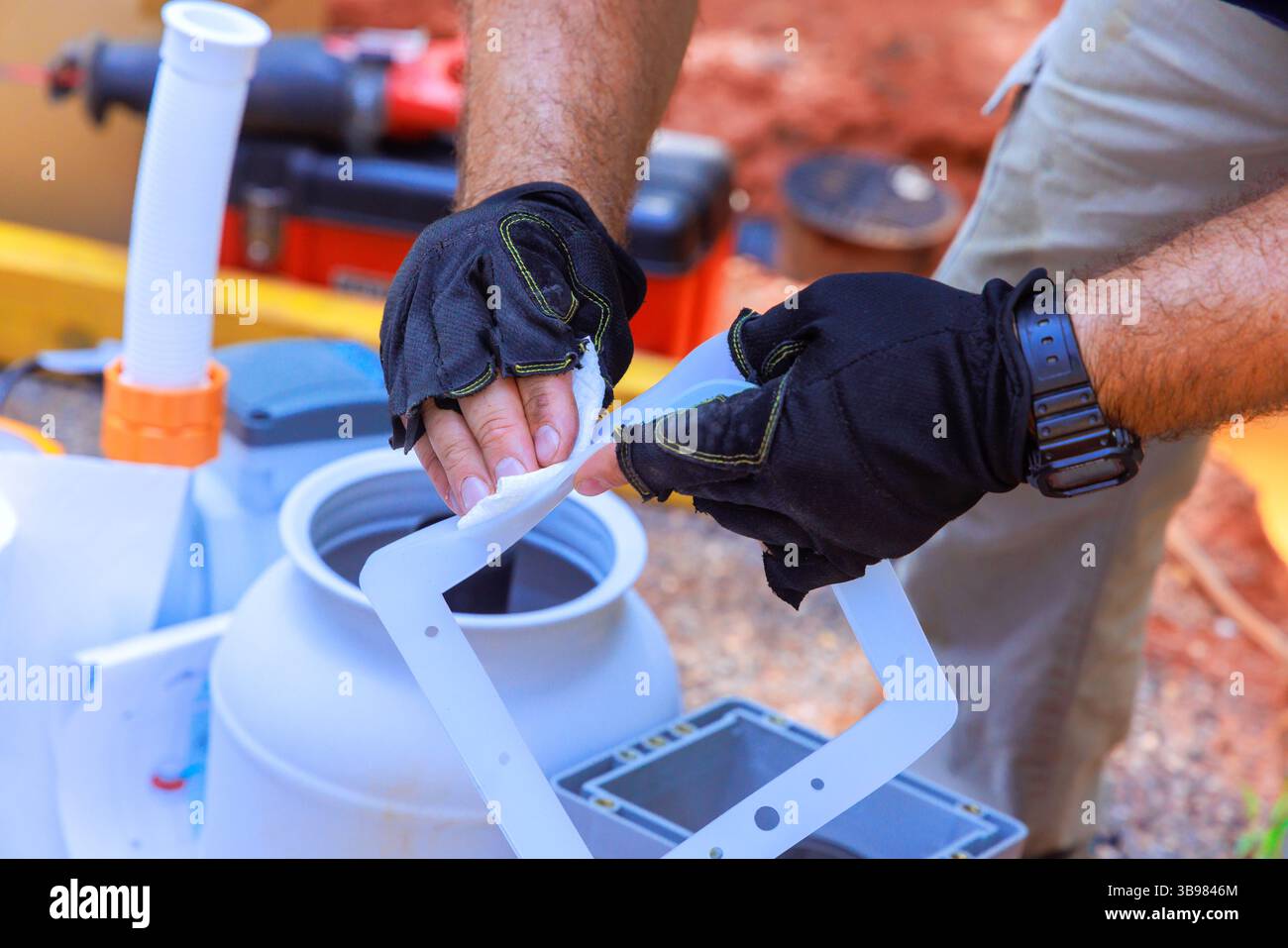 Hand in gloves cleans inspects filtration system parts to swimming pool ...