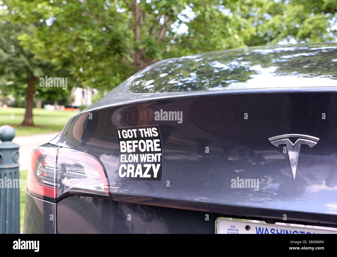 Sing On A Tesla Car in Washington, USA - 06 May 2025. A sign reading I ...