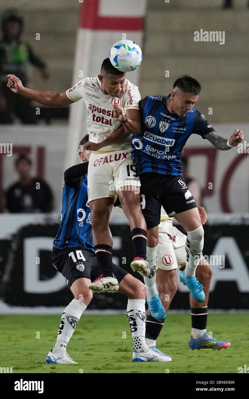 Edison Flores of Peru's Universitario de Deportes heads the ball ...