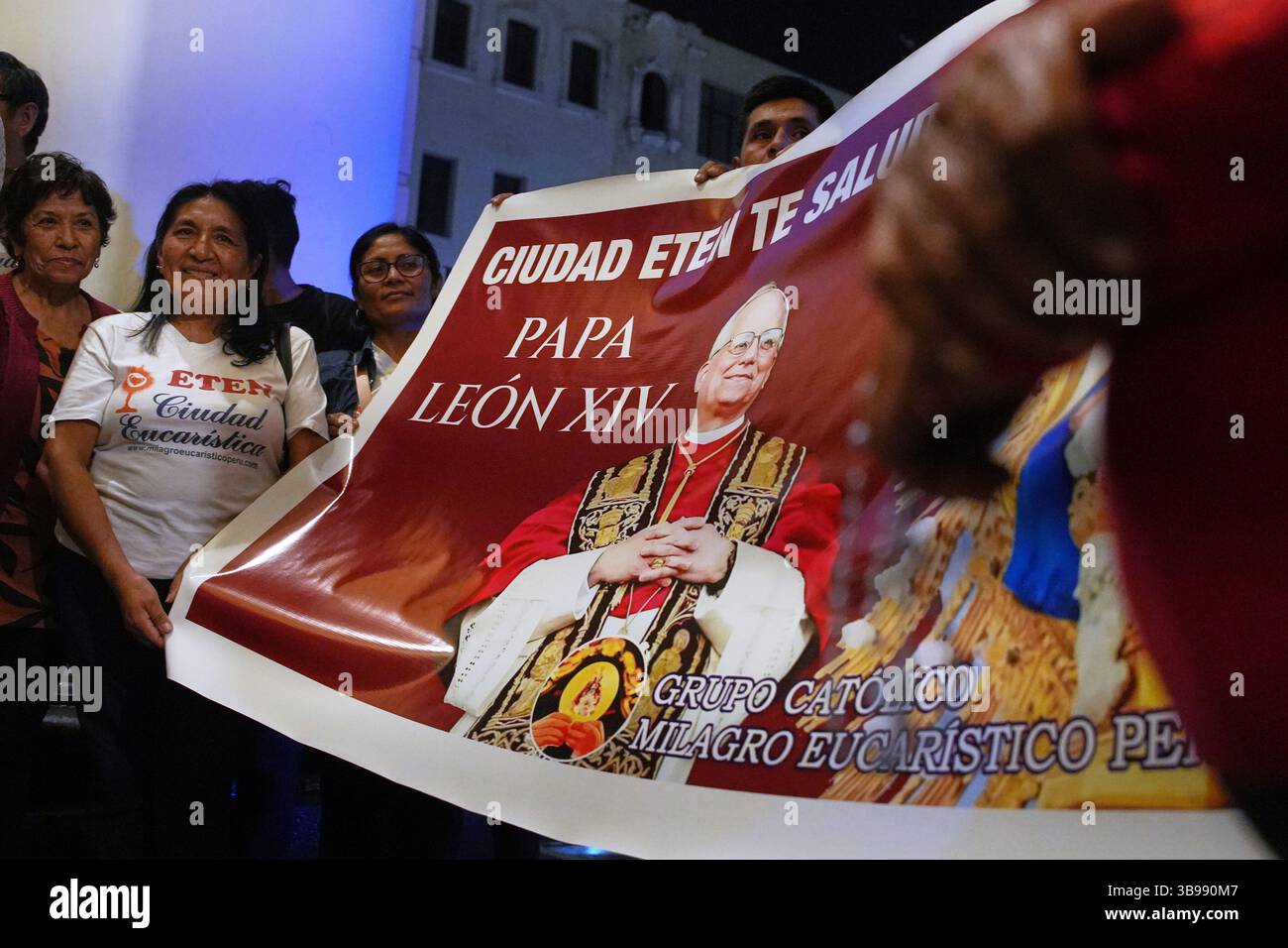 Parishioners hold up a banner of newly elected Pope Leo XIV at the ...