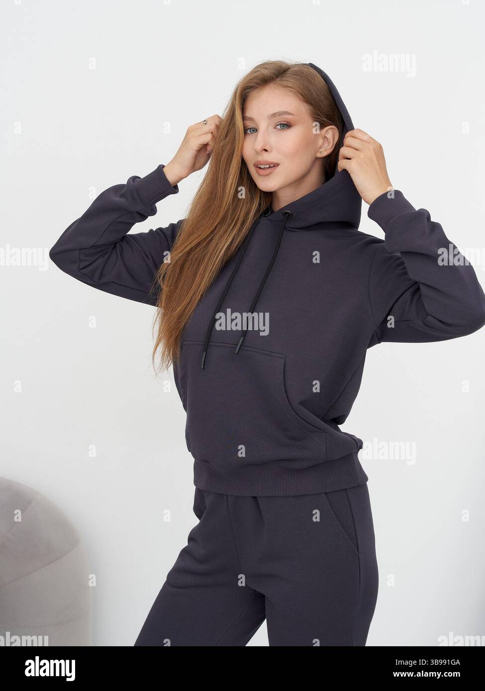 Stylish female model exuding confidence while posing in a chic studio ...