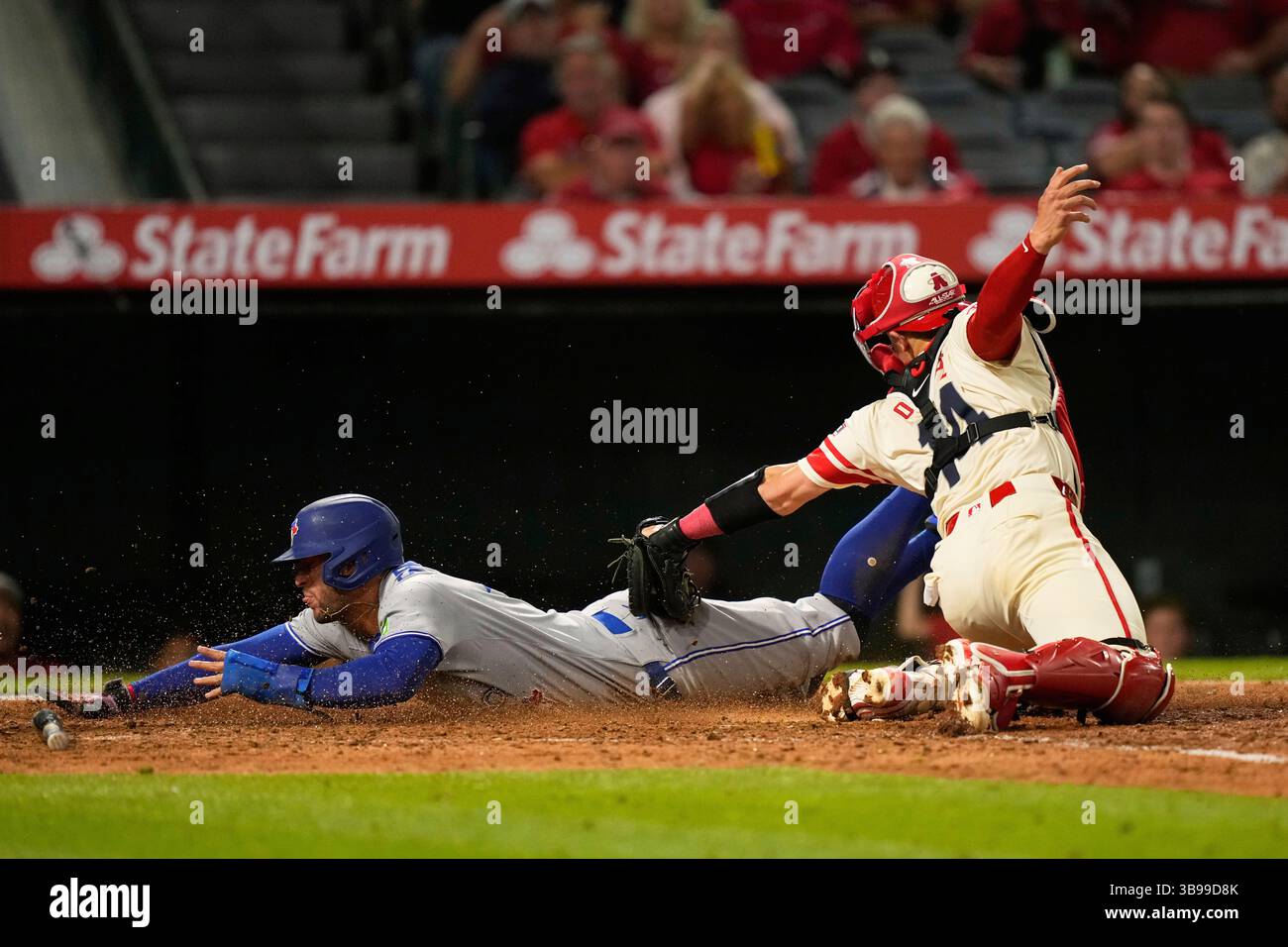 Toronto Blue Jays' George Springer, left, scores under the tag of Los ...