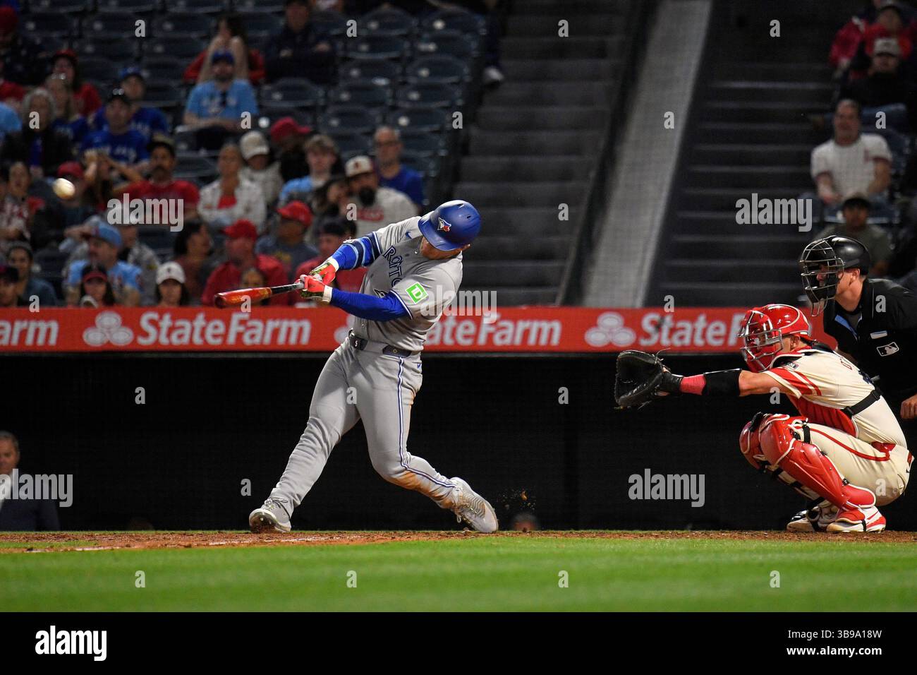 Toronto Blue Jays' Daulton Varsho, left, hits a solo home run as Los ...
