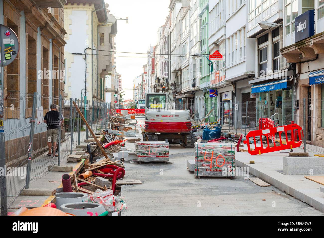 Repairing a road and laying communications using an excavator on the ...
