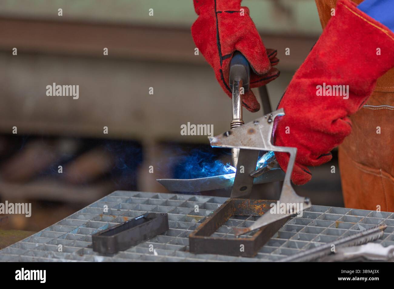 Details of welding activities - a welder is welding steel components ...