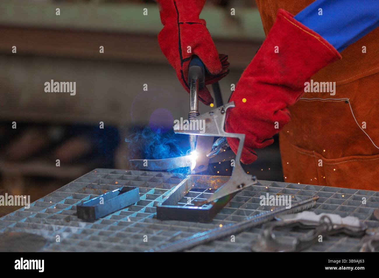Details of welding activities - a welder is welding steel components ...