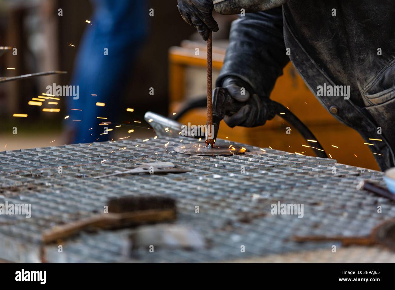 Details of welding activities - a welder is welding steel components ...