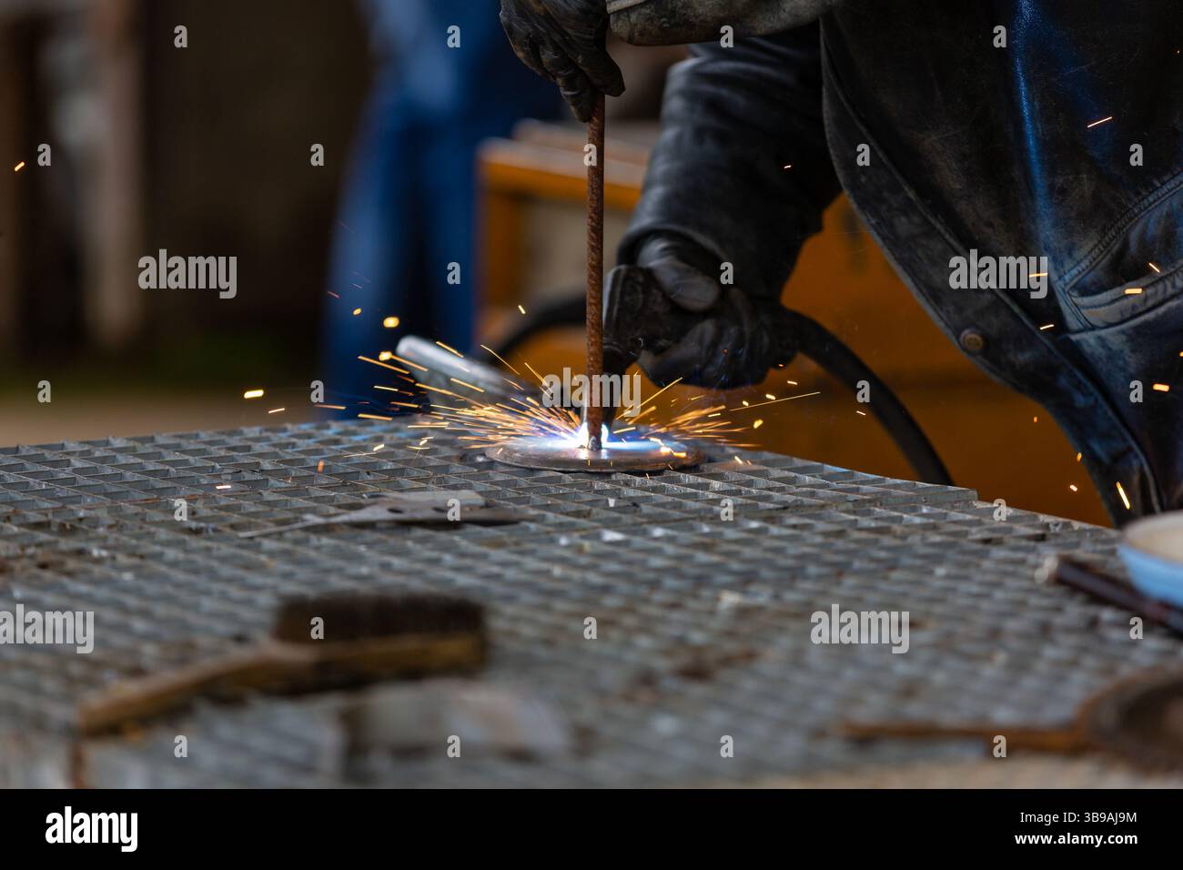 Details of welding activities - a welder is welding steel components ...