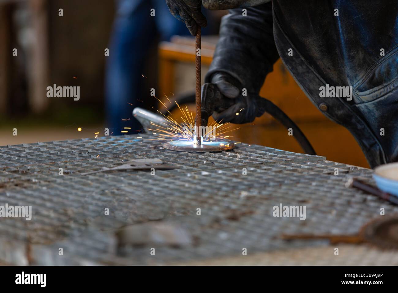 Details of welding activities - a welder is welding steel components ...