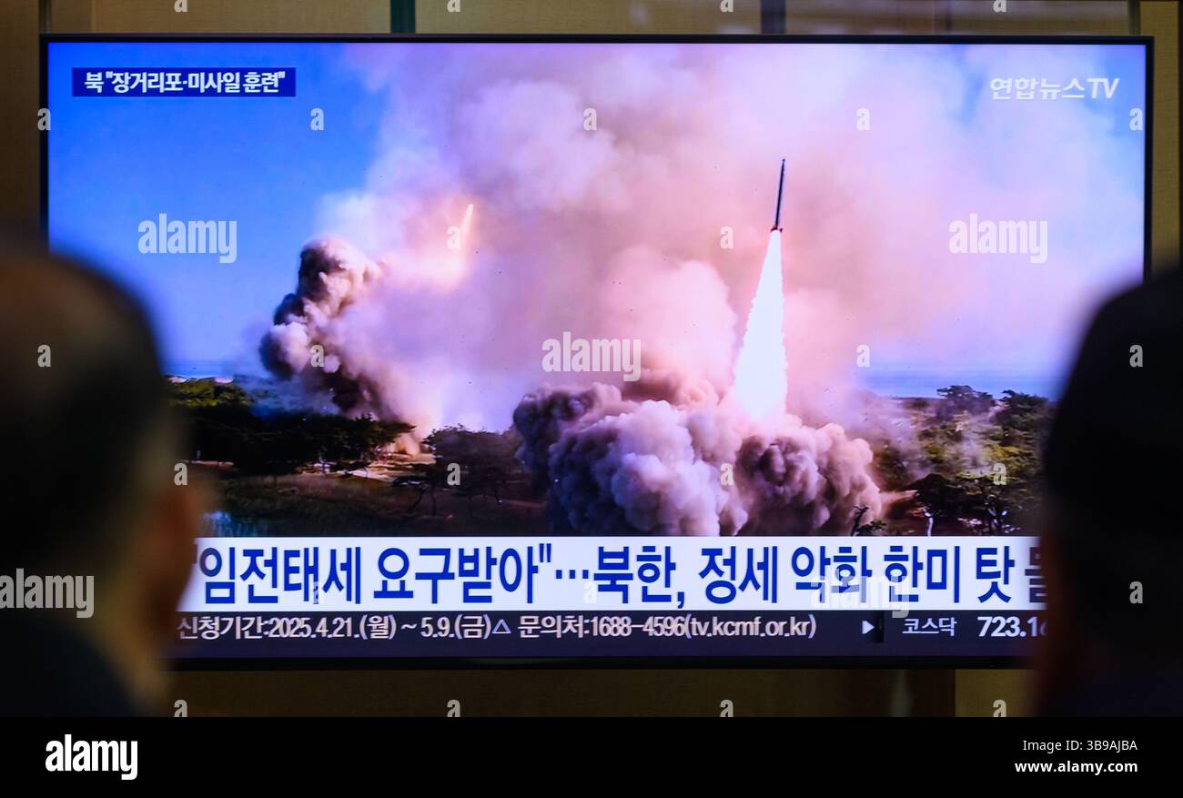 People look at a 24-hour Yonhap news TV broadcast at Seoul Railway ...