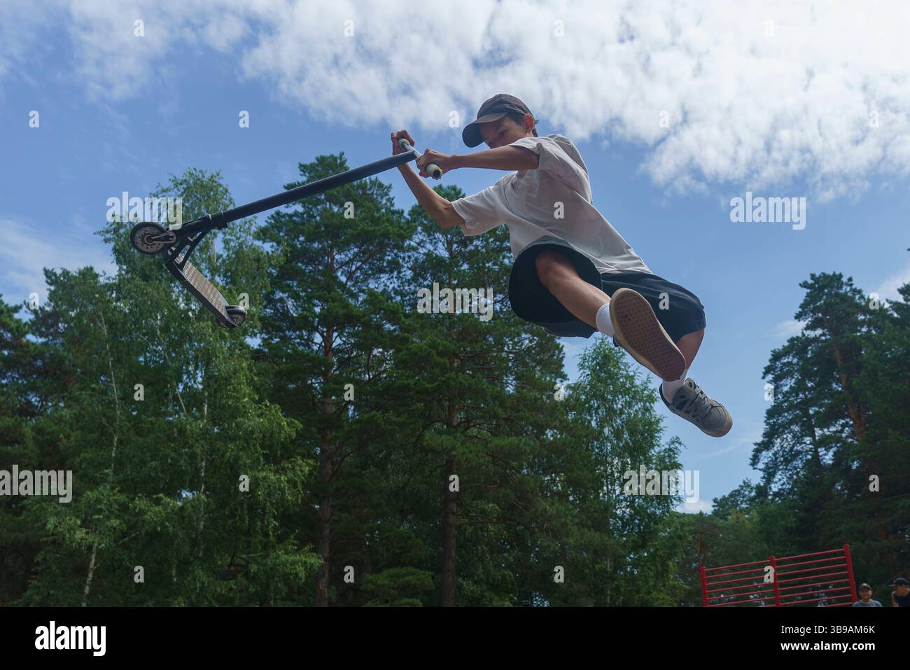the boy performs extreme stunts jumping with a scooter, extreme sports ...