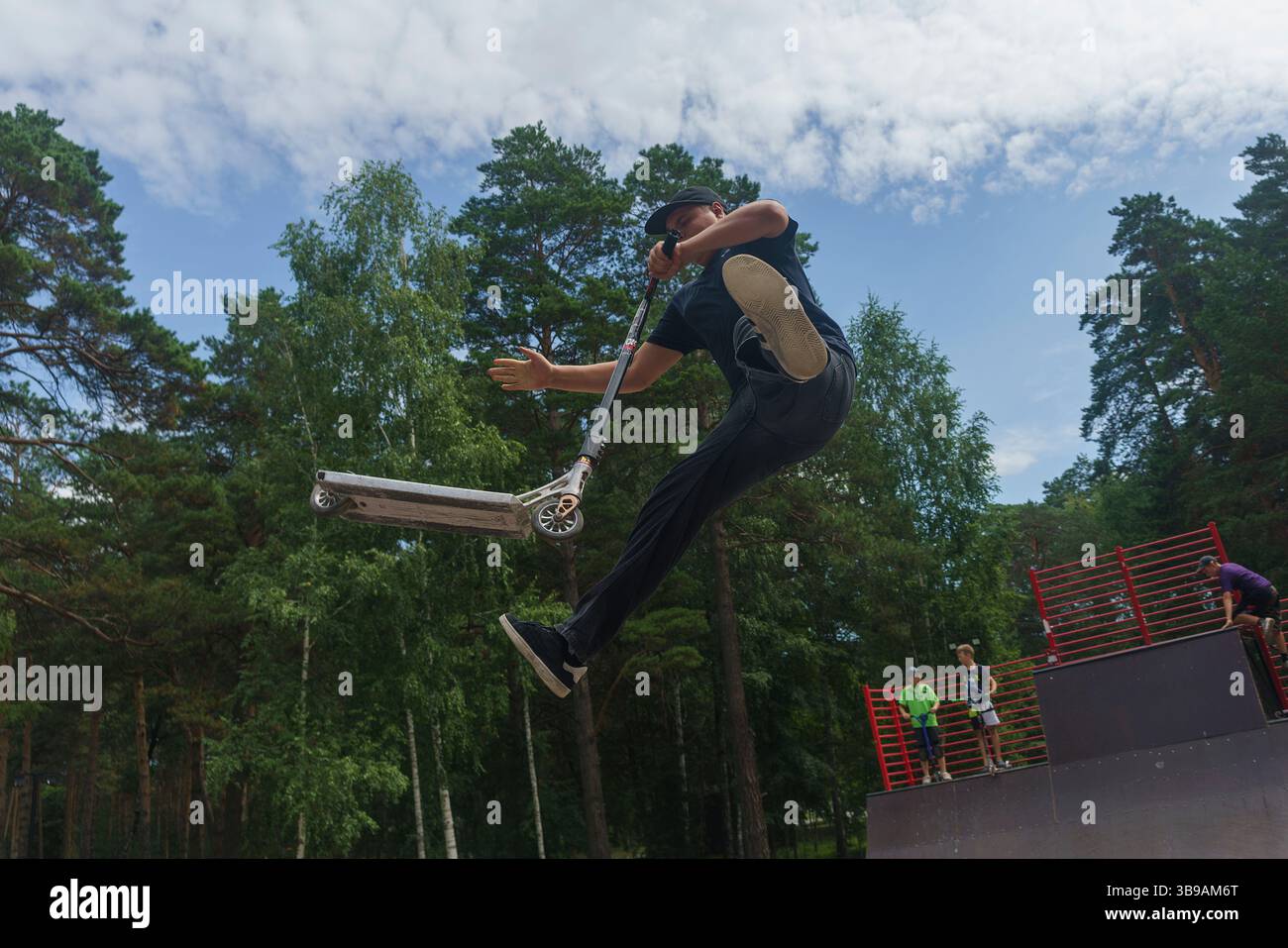 the boy performs extreme stunts jumping with a scooter, extreme sports ...