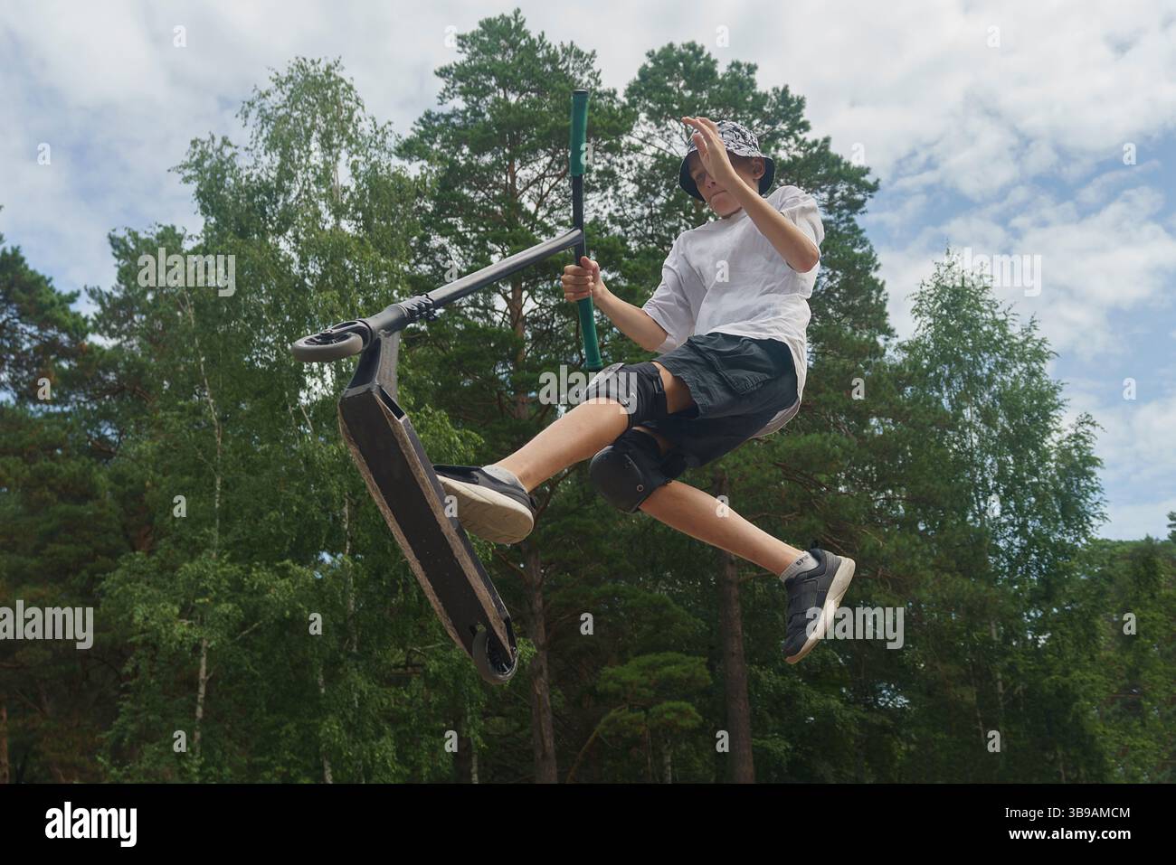 the boy performs extreme stunts jumping with a scooter, extreme sports ...