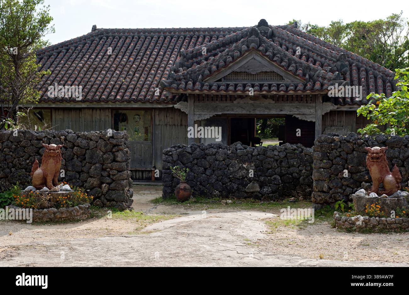 Traditional Okinawan residence with hinpun stone wall in front and ...
