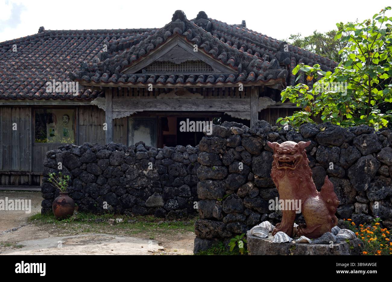 Traditional Okinawan residence with hinpun stone wall in front and ...