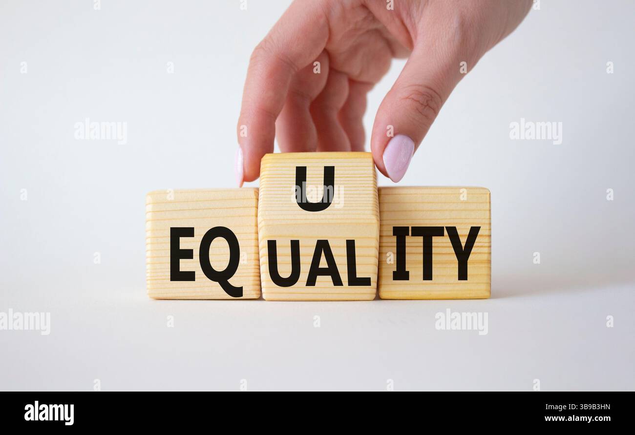 Equity and Equality symbol. Businessman hand turns wooden cubes and ...
