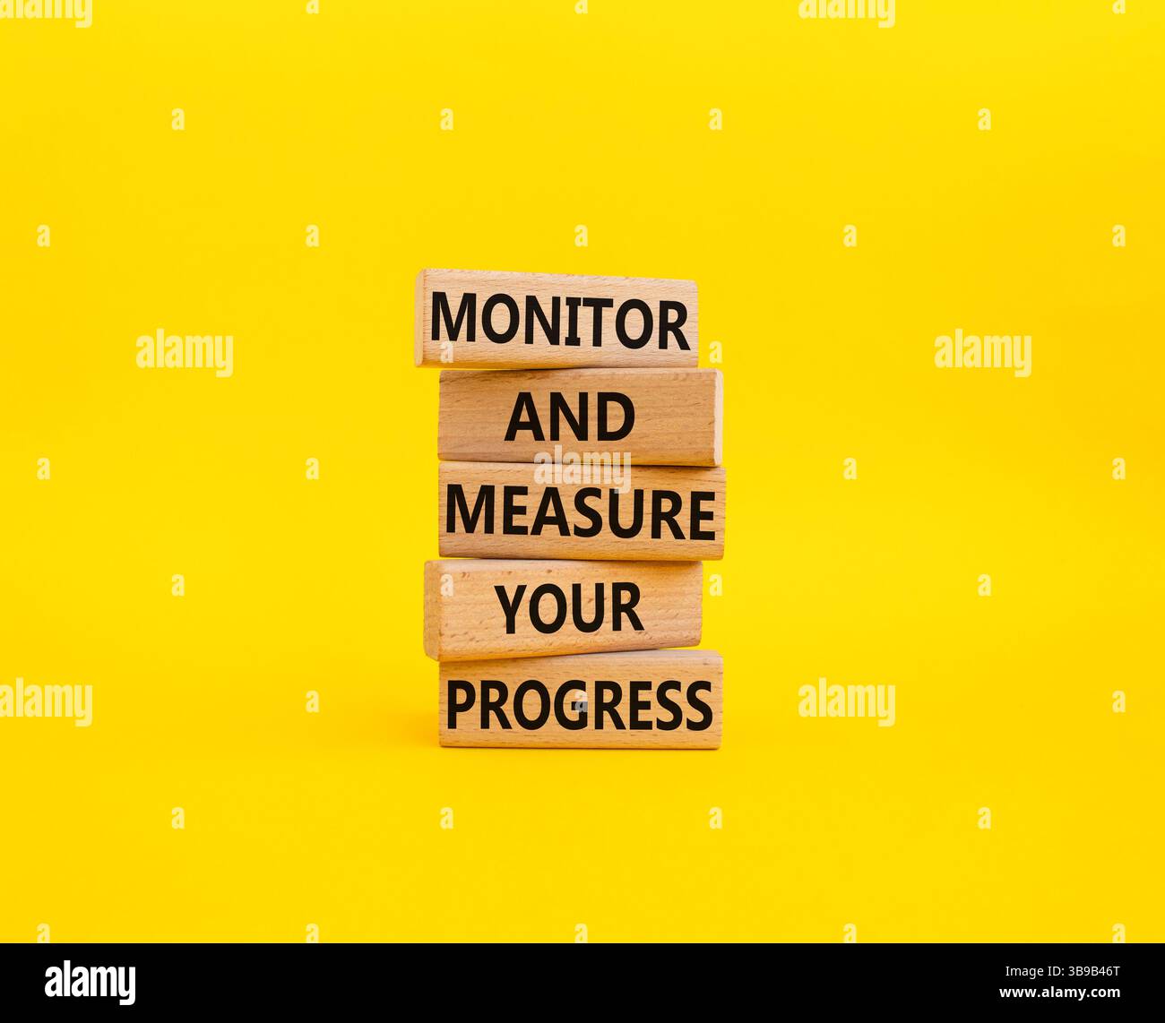 Monitor and Measure your Progress symbol. Wooden blocks with words ...