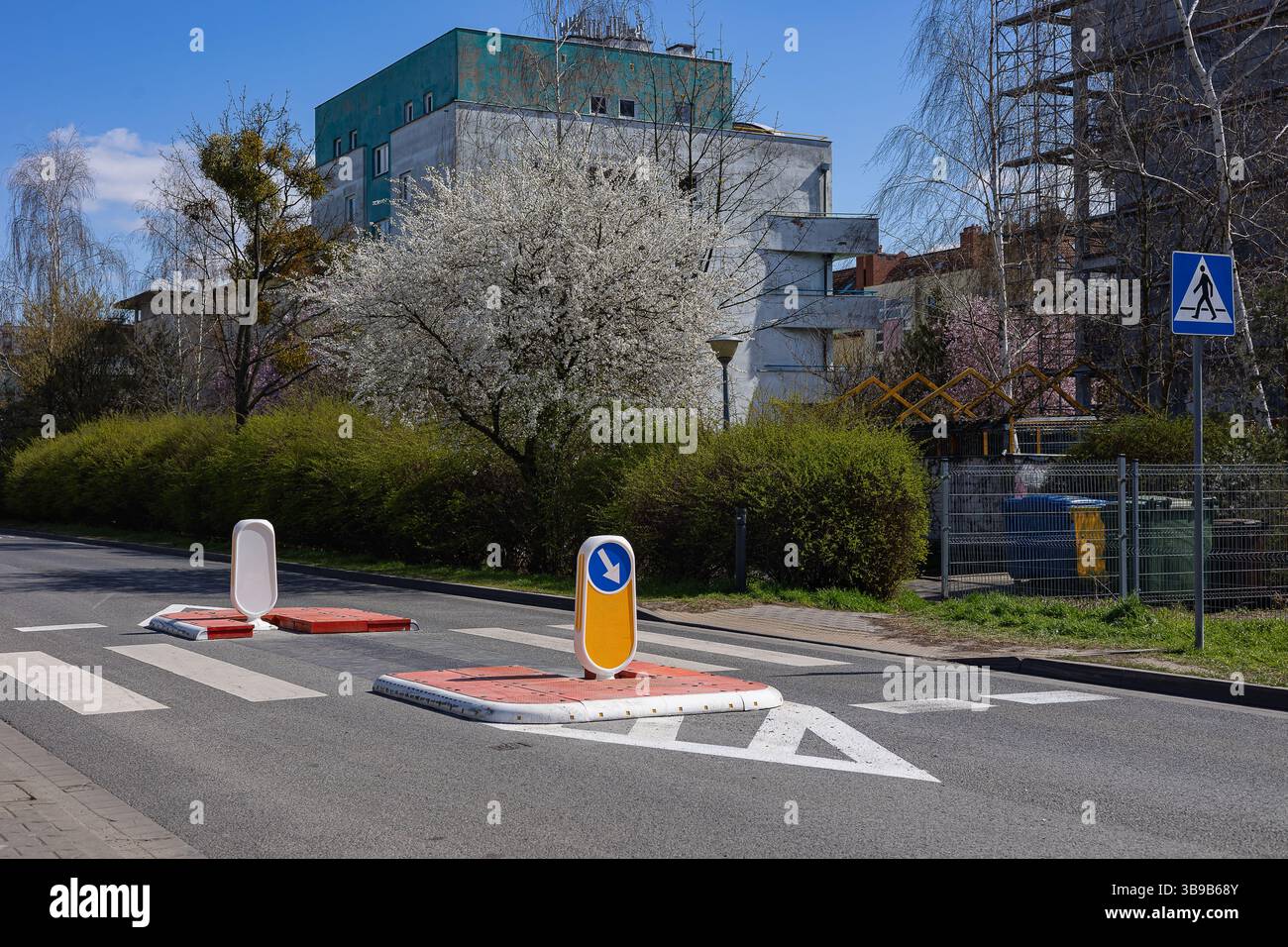 Urban road with freshly painted pedestrian crossing and temporary ...