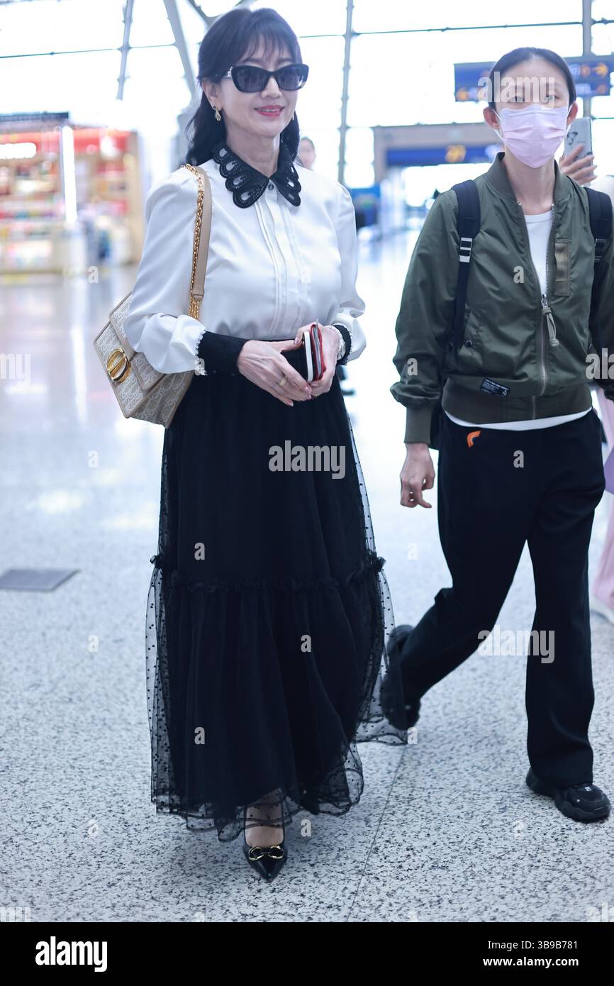 Hong Kong actress Angie Chiu appears at the airport in Shanghai, China ...