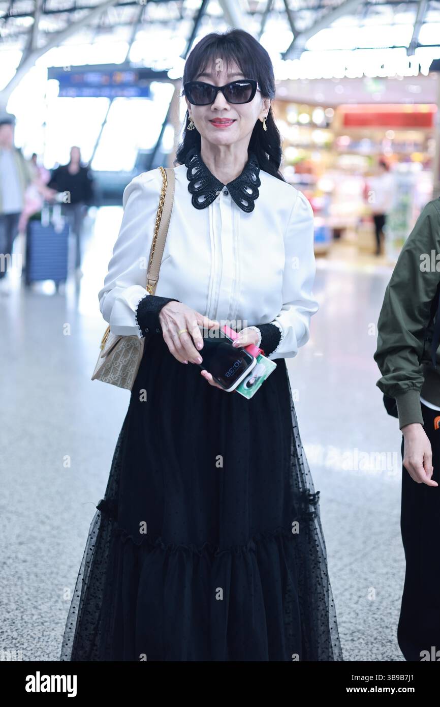Hong Kong actress Angie Chiu appears at the airport in Shanghai, China ...