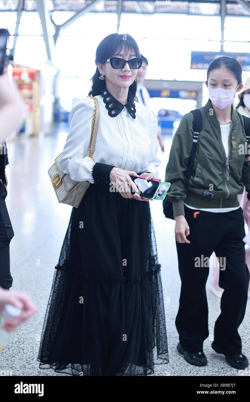 Hong Kong actress Angie Chiu appears at the airport in Shanghai, China ...