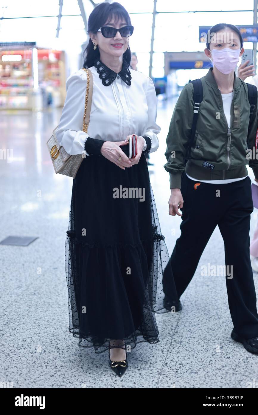Hong Kong actress Angie Chiu appears at the airport in Shanghai, China ...