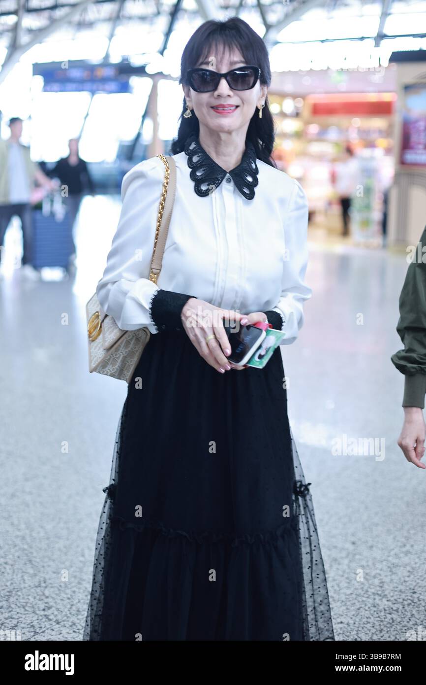 Hong Kong actress Angie Chiu appears at the airport in Shanghai, China ...