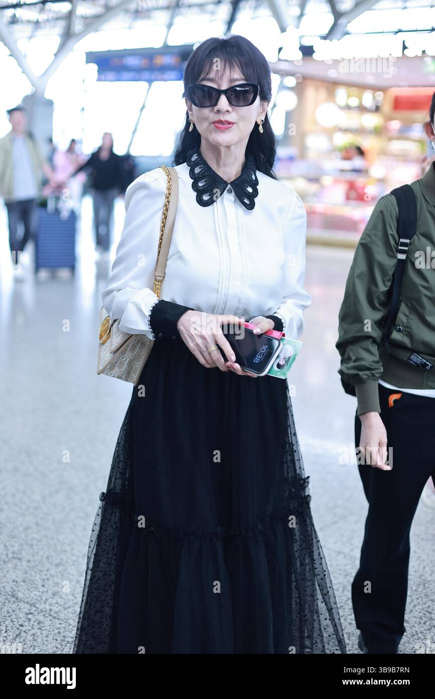 Hong Kong actress Angie Chiu appears at the airport in Shanghai, China ...